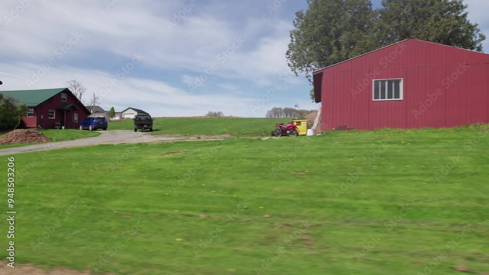 Driving around small town America in Ohio countryside, moving past wood ...