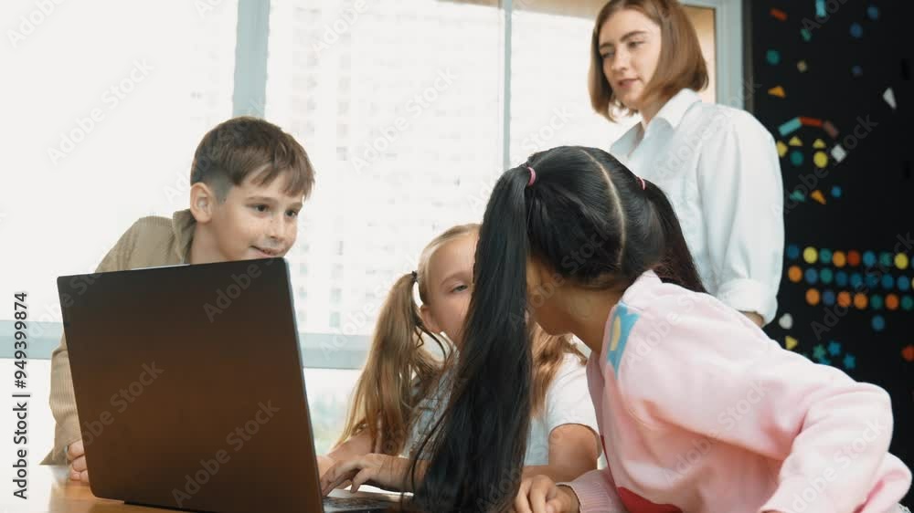 Young teacher looking at diverse student presentation in laptop and ...