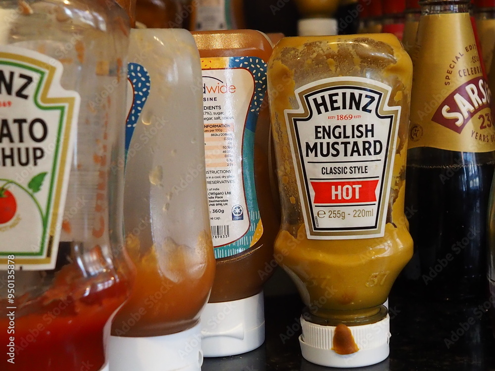 bottles of British condiments inside a pub restaurant, mayonnaise ...