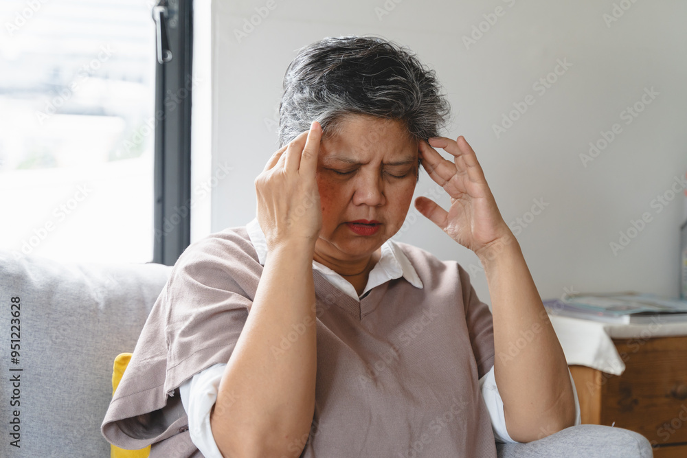 Elderly women feeling dizzy and headache sit on the sofa at home. Stock ...