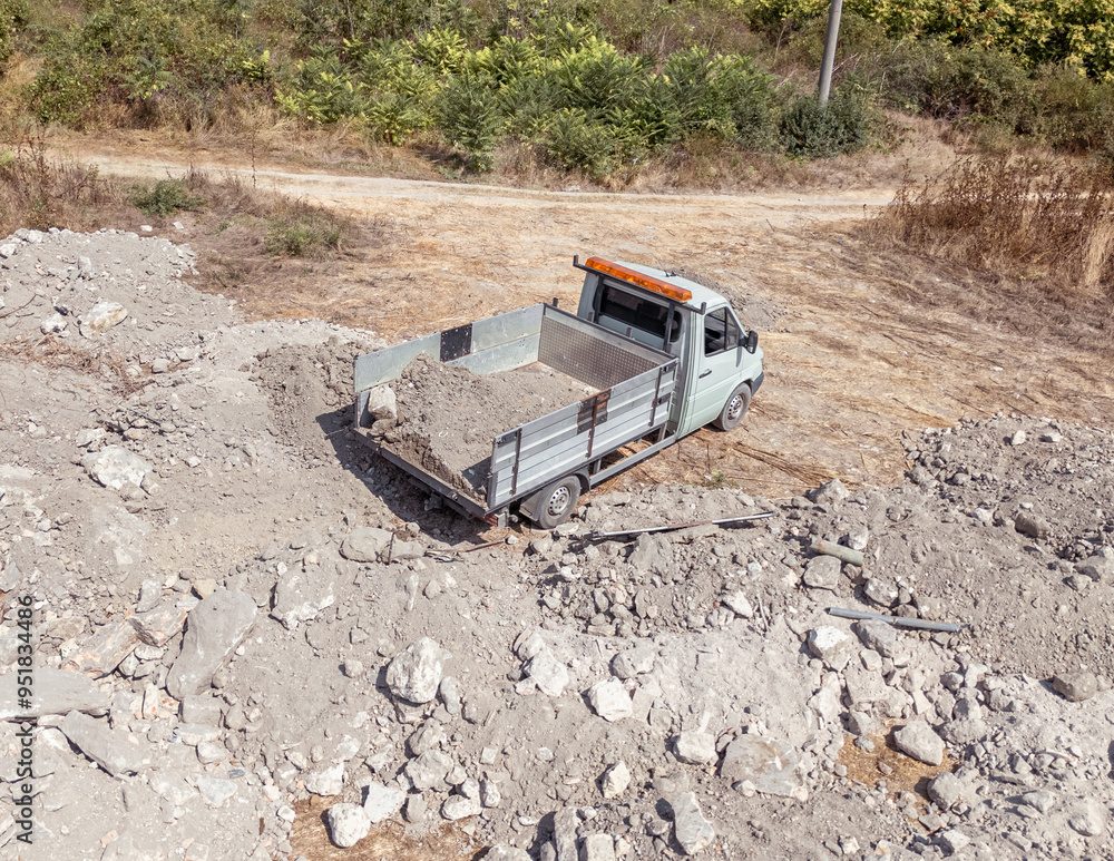 Small dump truck removes soil from a new construction site. Digging a ...