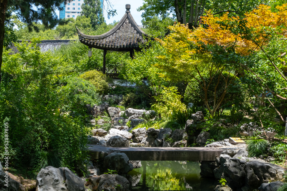 A beautiful traditional Chinese garden featuring a traditional pavilion ...