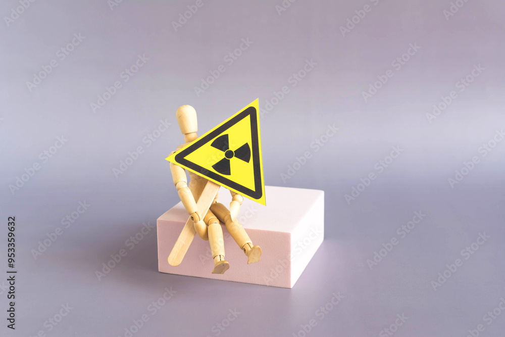 A mannequin is sitting on a podium and holding a sign of attention ...