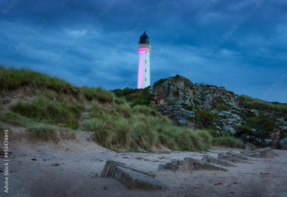 Stormy afternoon on the beach with a view of the lighthouse in the town ...