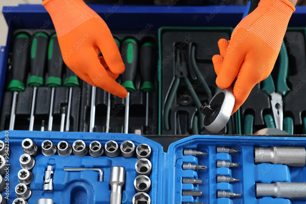Auto mechanic with torque wrench and different tools at automobile ...