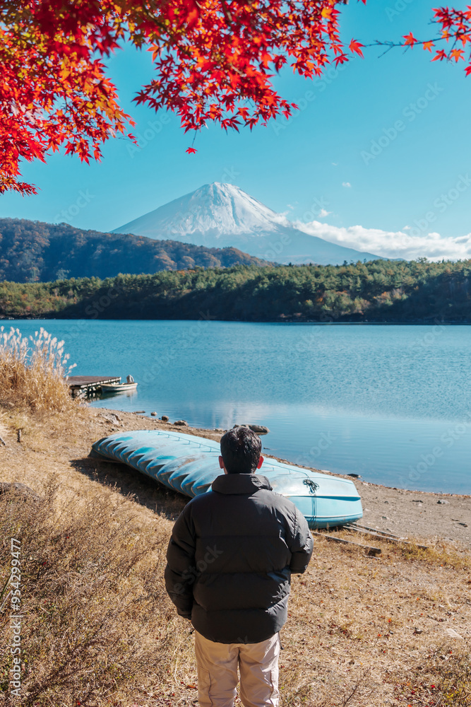 man tourist with Fuji Mountain at Lake Saiko in Autumn season, happy ...