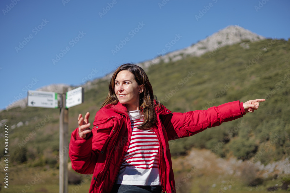 Young hiker pointing in the right direction of the route. Nature ...