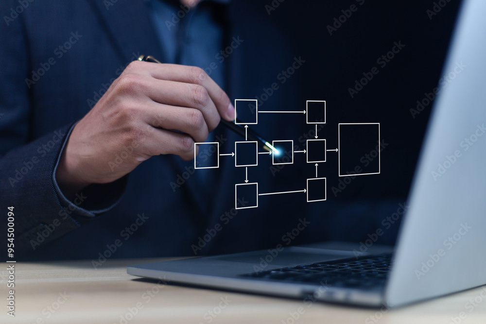 Foto de Businessman designs automated workflows with flowcharts on ...