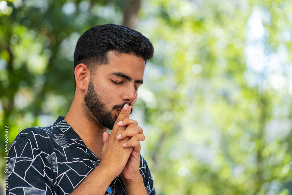 Bearded religion Indian man tourist praying with closed eyes to God ...