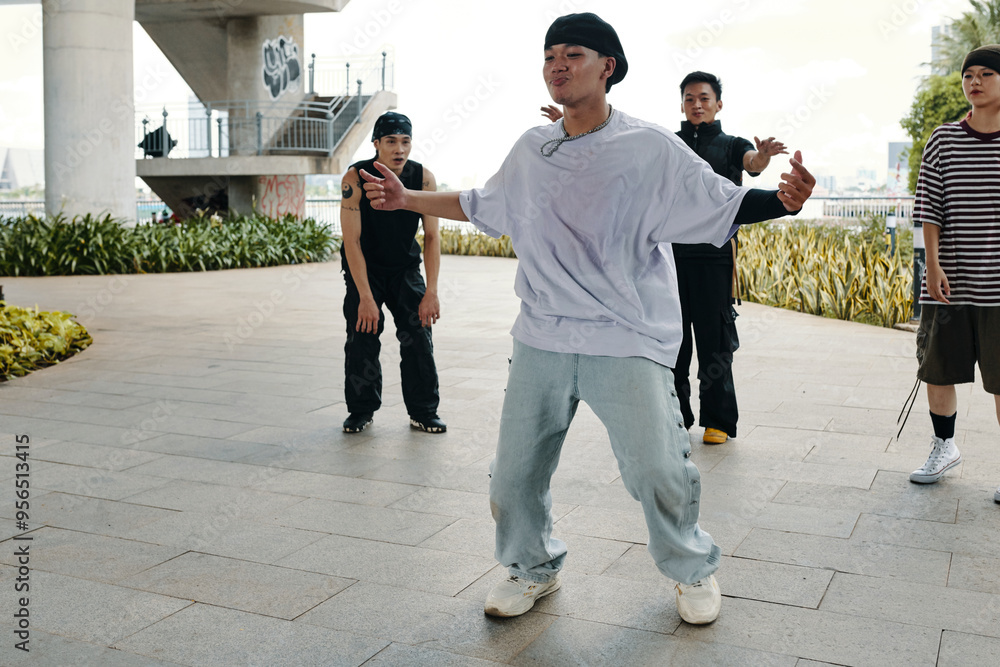 Group of friends performing dance routine in urban setting with ...