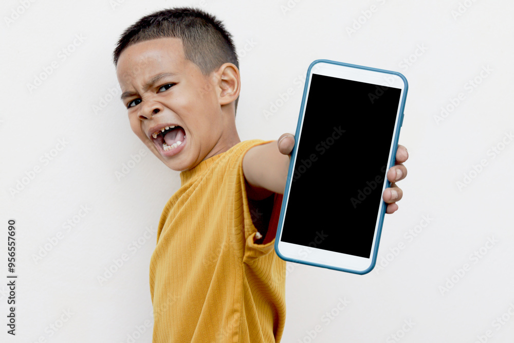 Anger six year old Asian little boy in a yellow shirt holding mobile ...