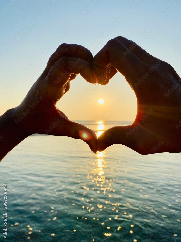 Sea, sun, love. Love sign, hand heart symbol in afternoon sunset ocean ...