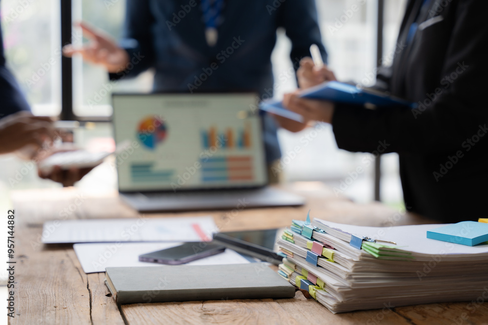 Business Meeting: A focused discussion unfolds around a laptop ...