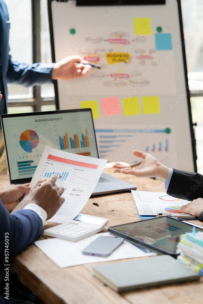 Strategic Vision in Action: A team collaborates, analyzing charts and ...