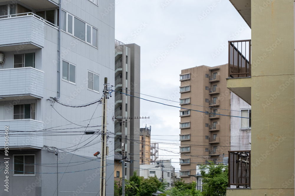 A quiet Japanese residential area flanked by mid-rise apartment ...