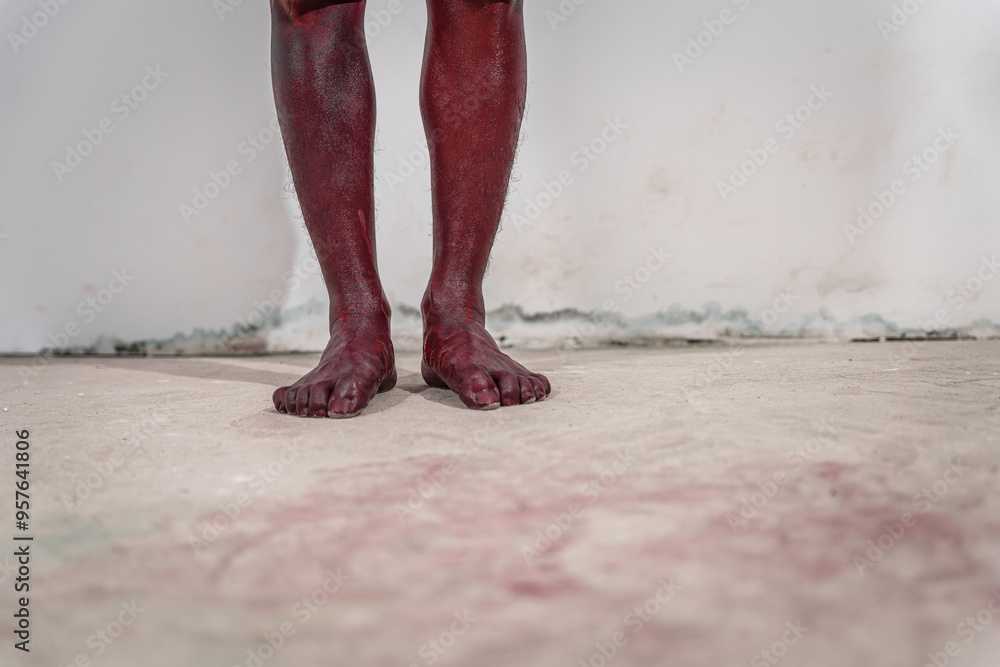 Dirty and horrifying red zombie feet displayed on white studio ...