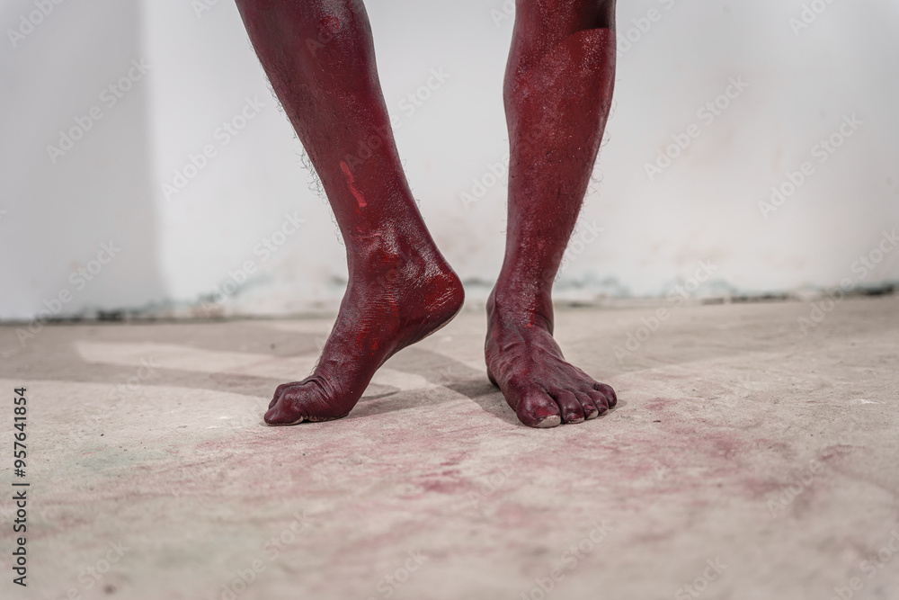Dirty and horrifying red zombie feet displayed on white studio ...