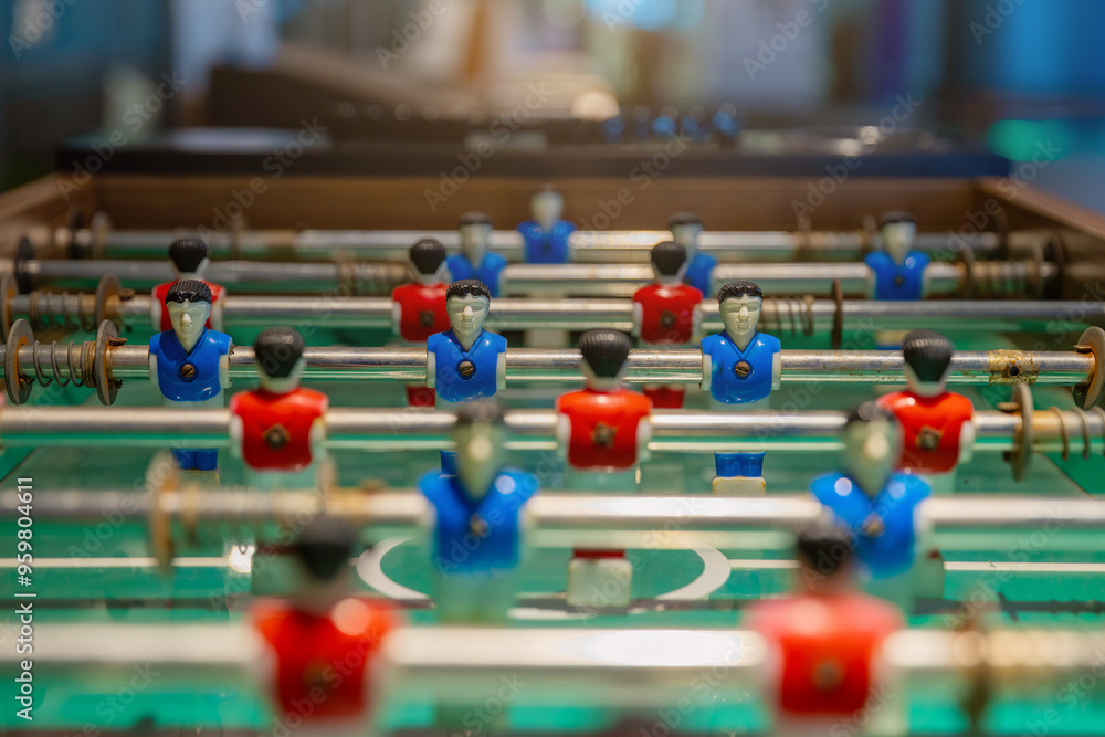 Retro table soccer with wooden miniature figurines of players on metal ...