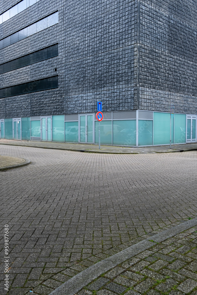 An empty city street corner, surrounded by modern buildings with a mix ...