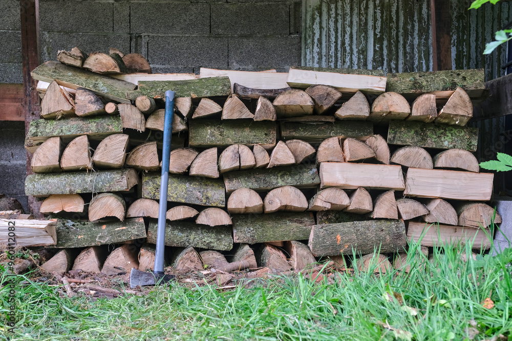 Stack of firewood, made up of logs arranged in staggered rows, in a ...