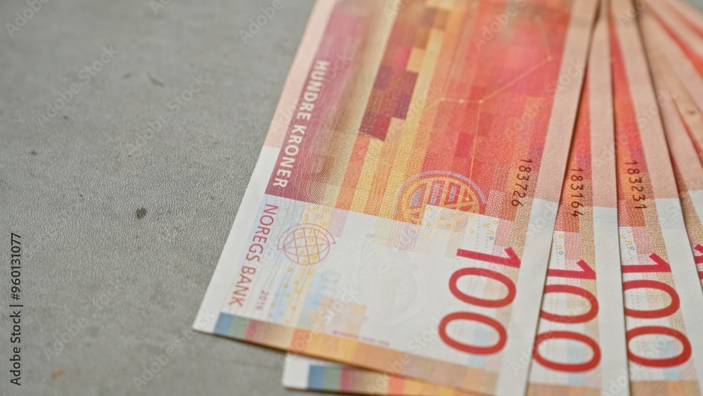 Norwegian banknotes in denominations of one hundred kroner are neatly ...