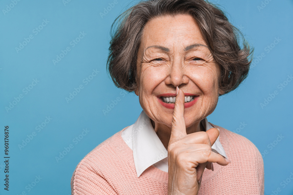 Smiling positive woman female pensioner holding finger on lips mouth ...