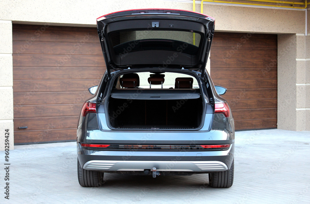Modern car with open empty trunk outdoors. Black car is ready to load ...