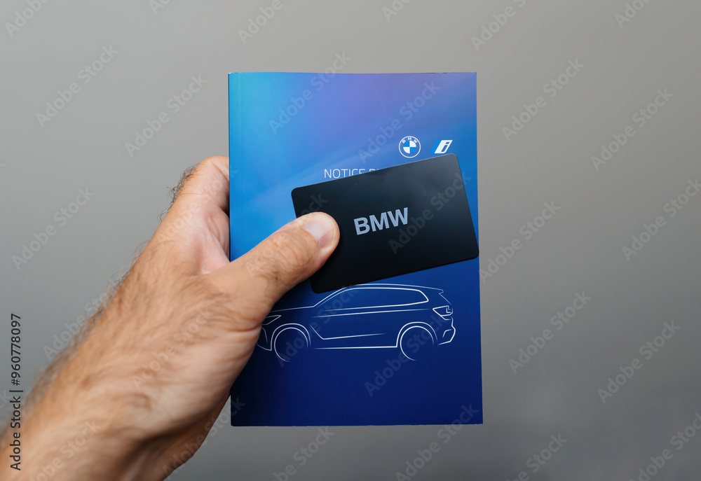 Munich, Germany - Sep 2, 2024: A male hand displays the new BMW Car ...