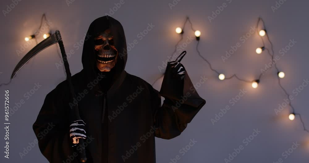 Mysterious person in grim reaper death costume standing with scythe on ...