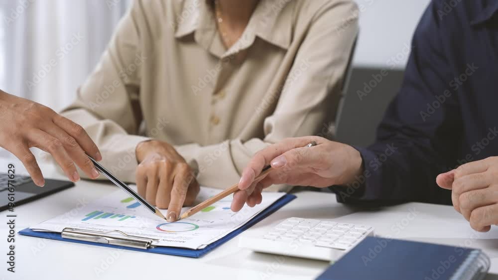 Strategic Alignment: Three business professionals collaborate closely ...