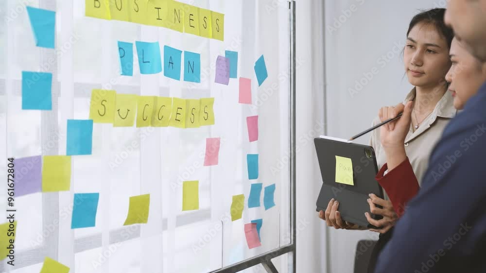Brainstorming Session: A collaborative team analyzes sticky notes on a ...