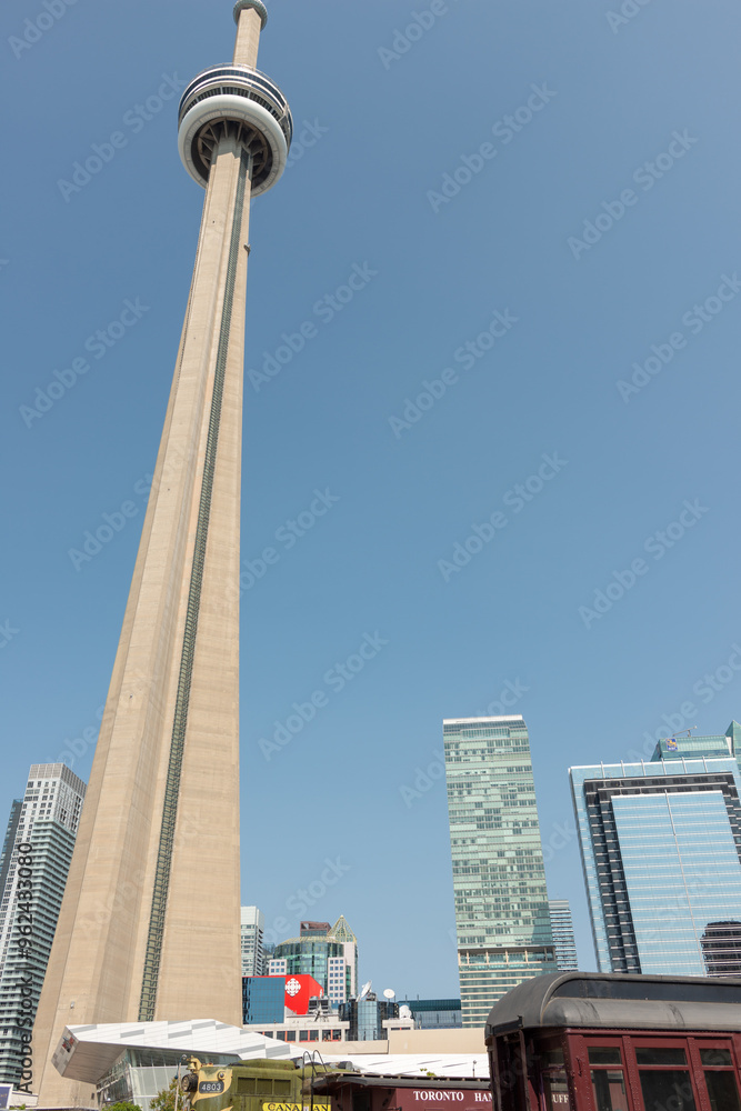 truncated view of the CN Tower contrasting its scale with buildings ...