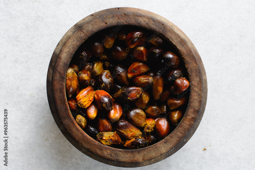 Overhead view of fresh palm nuts in a wood mortar, top view of palm ...