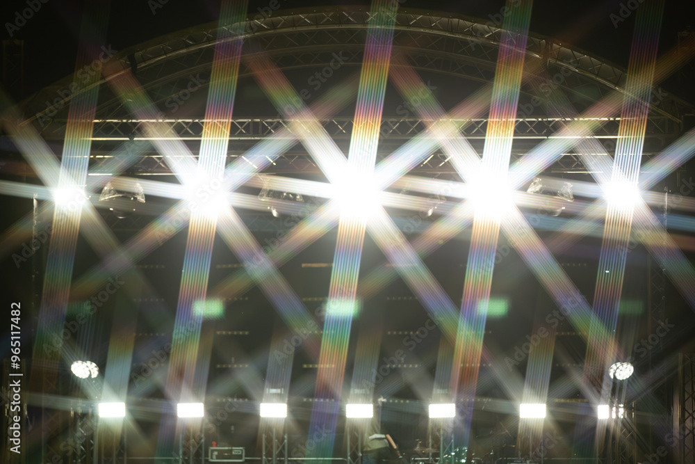A powerful display of bright stage lights creates a vibrant starburst ...