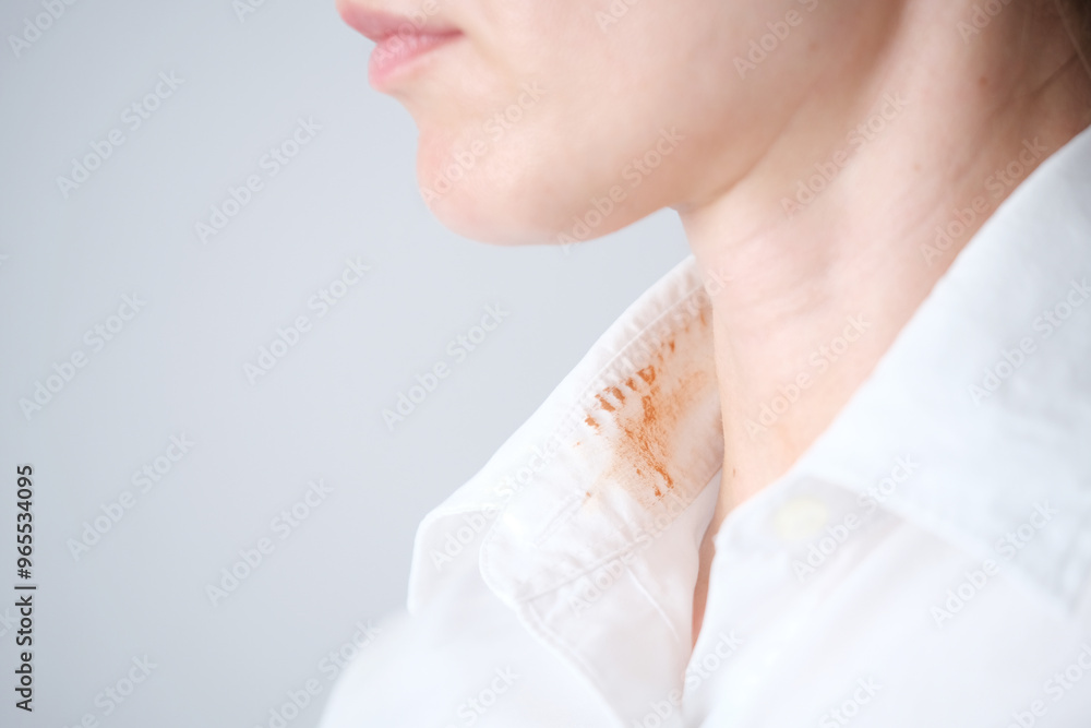 Faceless woman showing a dirty cosmetic stain on the collar of his ...