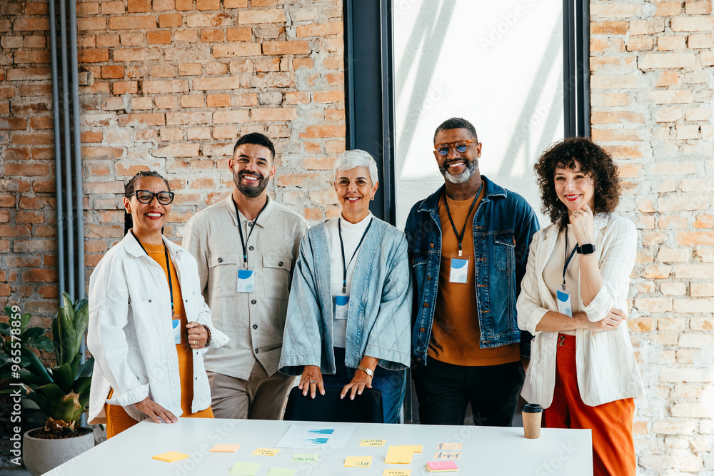 Multicultural young and senior professionals collaborating in a ...