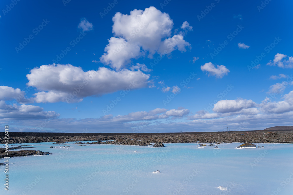 Milky blue waters of the Blue Lagoon in Iceland contrast with black ...