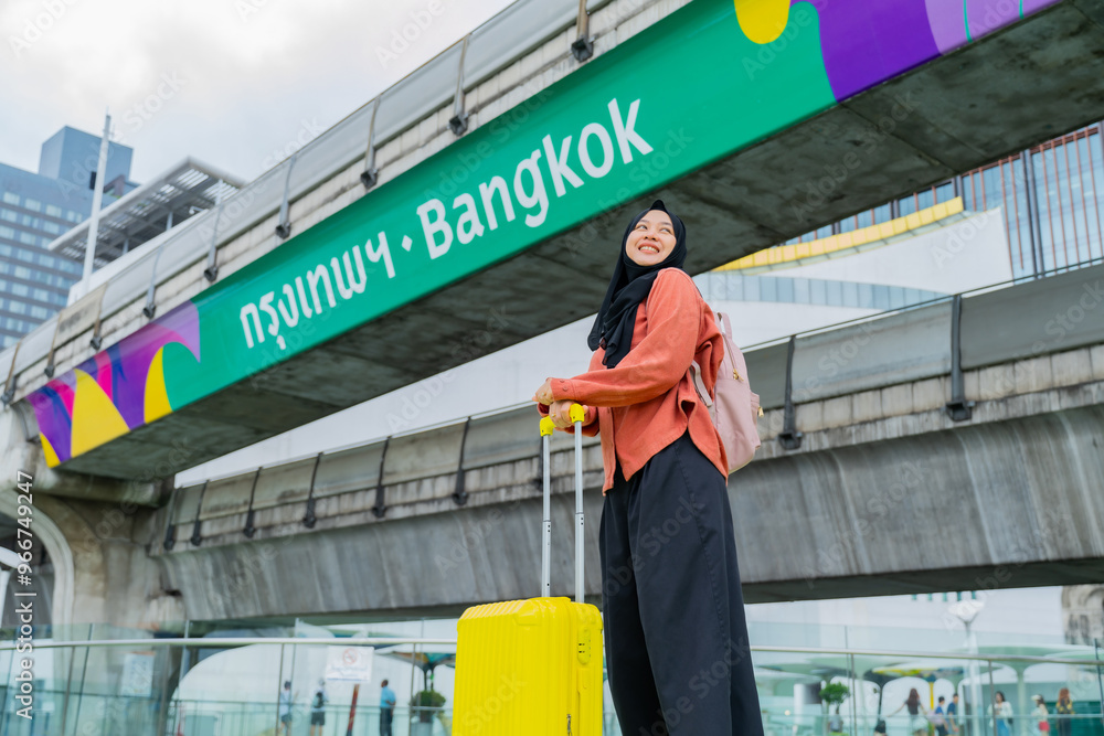Muslim woman traveler with luggage relaxing and enjoying in Sky walk .Famous destinations in ...