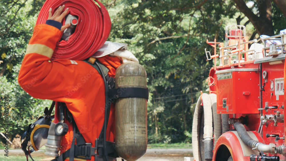 Fireman prepare equipment at fire engine truck. Man hand connect water ...