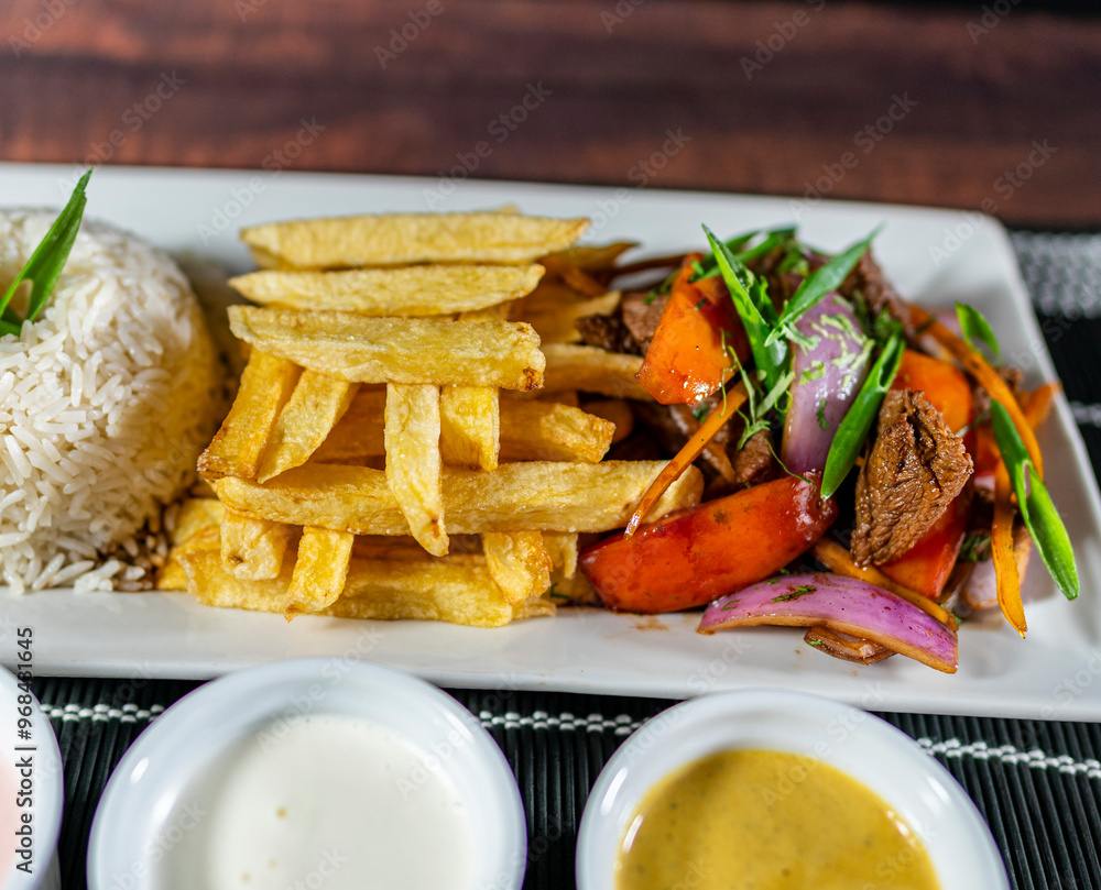 beef lomo saltado, french fries and rice, served with homemade creams ...