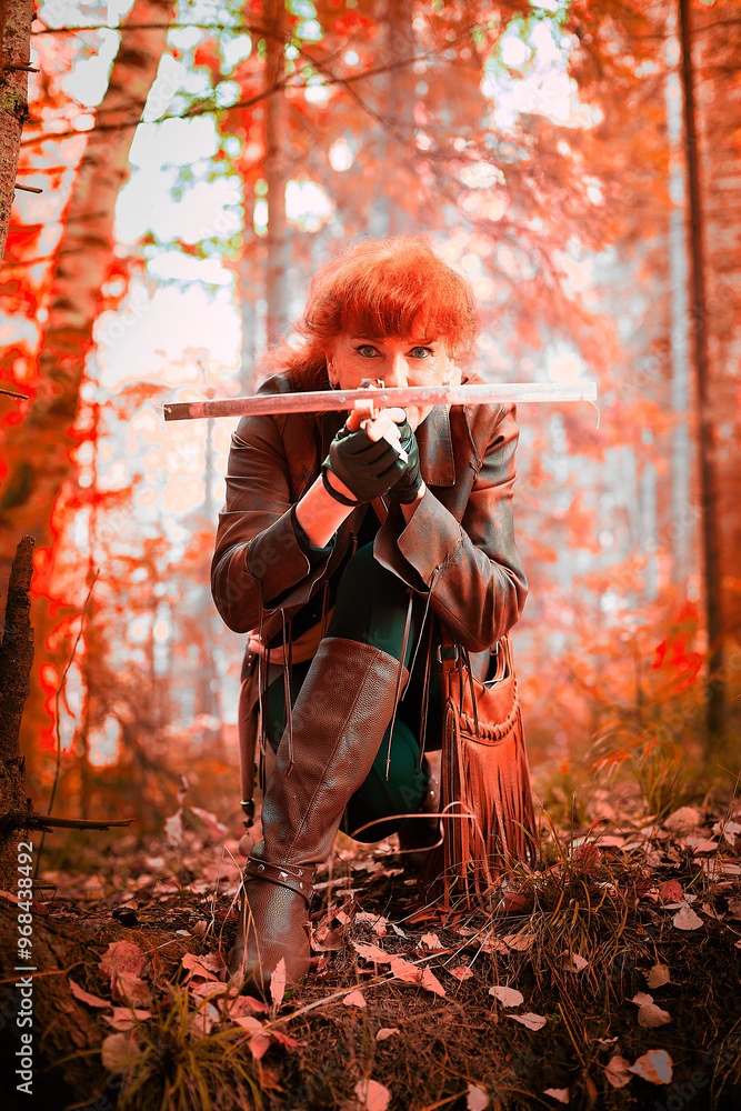 Mature model portraying a royal huntress with red curve hair is hunting ...