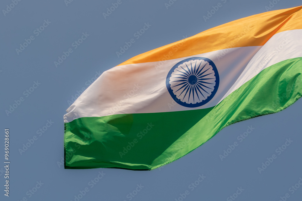 Flag of India fluttering against blue sky. Flag of India, national ...