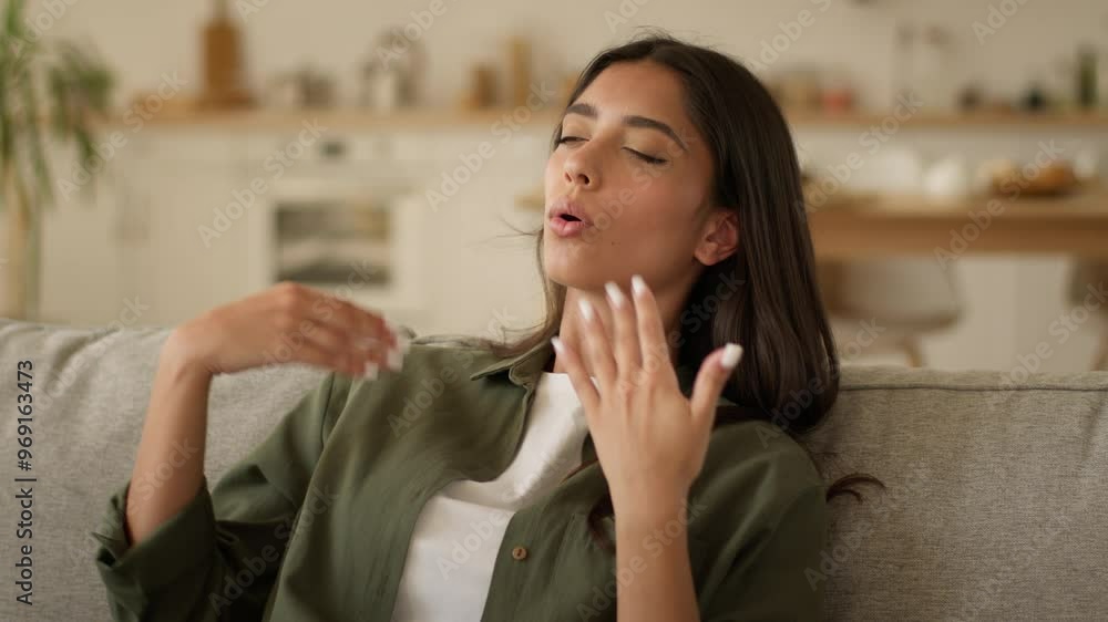 Upset sad overheated Indian woman suffering at home wave hand refresh ...