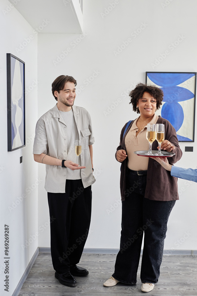 Vertical full length portrait of two smiling adult people holding ...