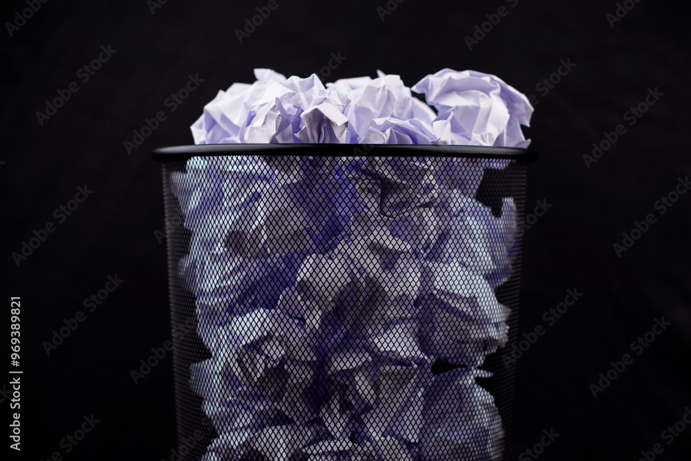 Trash can and scrap paper Photo of black trash can and white crumpled ...