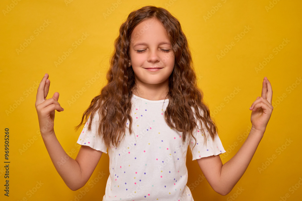 Calm smiling girl with wavy brown hair practicing yoga indoors on ...