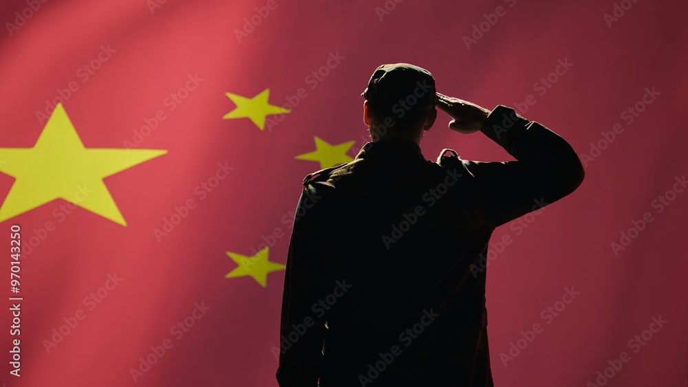 Member of chinese army doing saluting hand gesture towards China flag ...