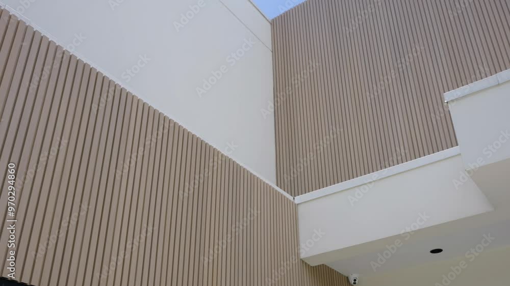 Interior wall with vertical lines creating textured pattern. Ceiling at ...