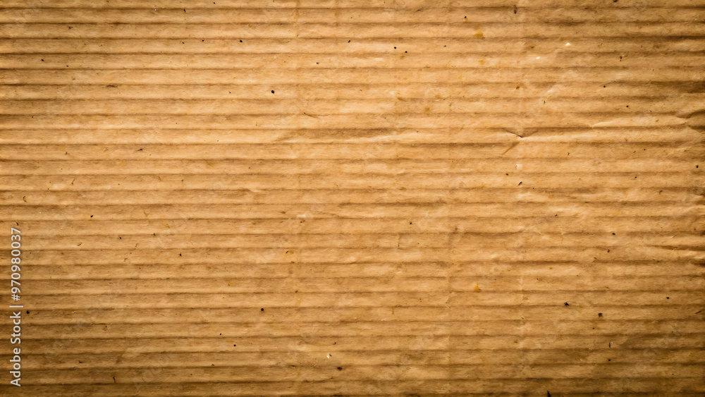 Parallel ridges and dark spots on brown corrugated cardboard, a ...