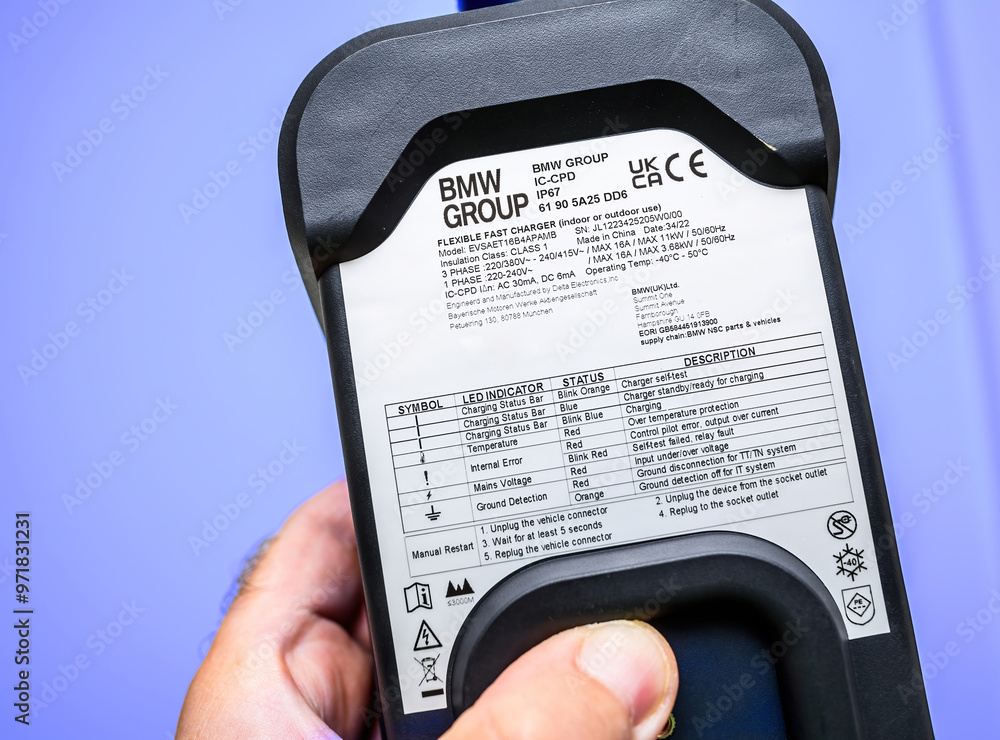 Paris, France - Sep 3, 2024: A male hand holds the latest BMW digital ...